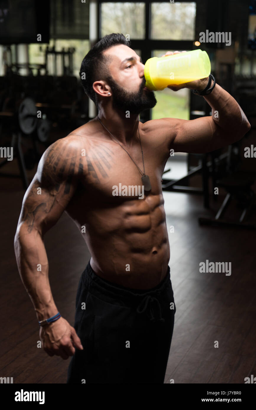 Muscular Man Resting After Exercise And Drinking From Shaker Stock ...