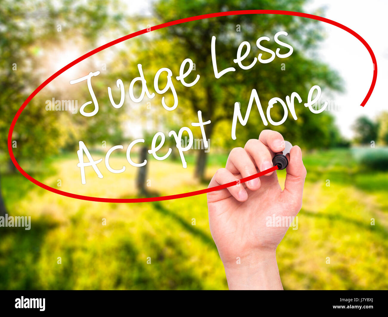 Man Hand writing Judge Less Accept More with black marker on visual ...