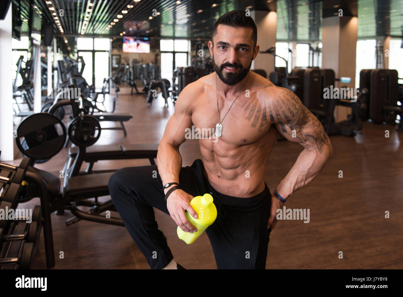 Muscular Man Resting After Exercise And Drinking From Shaker Stock ...