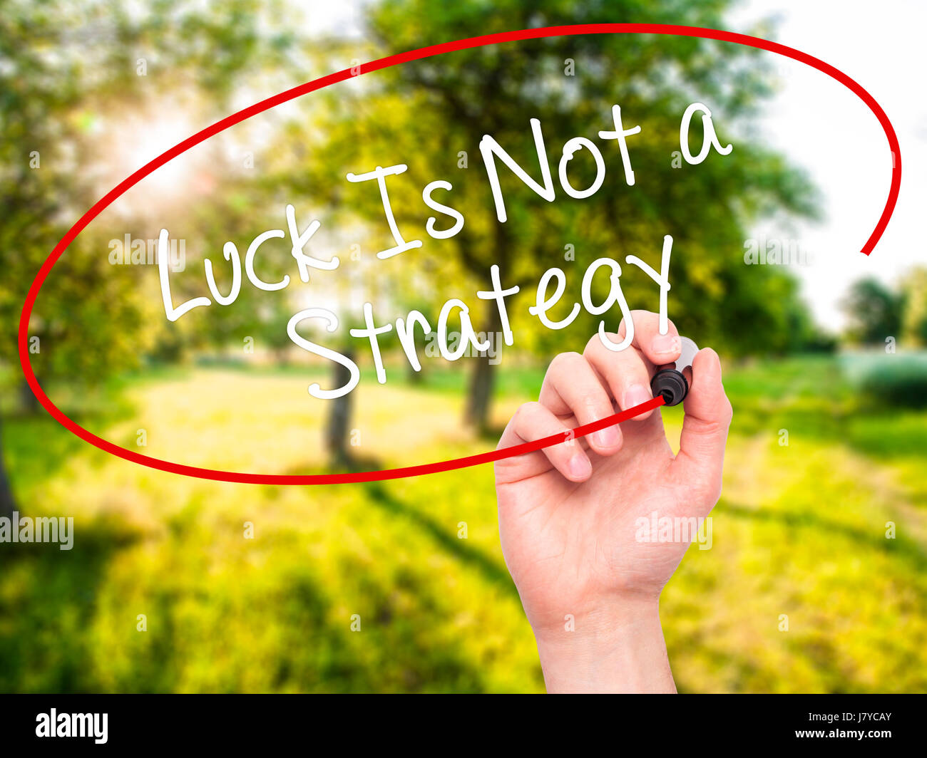 Man Hand writing Luck Is Not a Strategy with black marker on visual ...