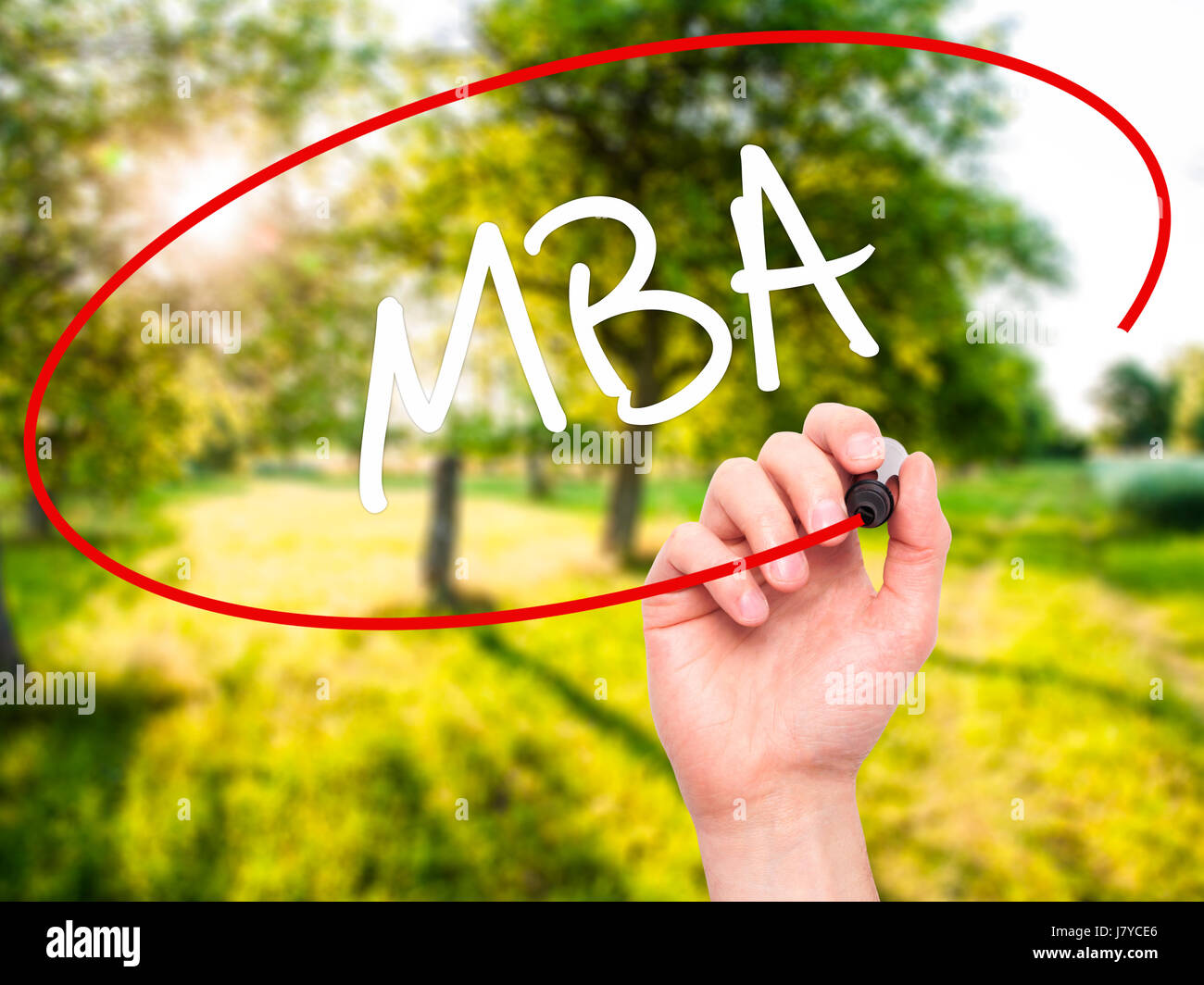 Man Hand writing MBA with black marker on visual screen. Isolated on ...