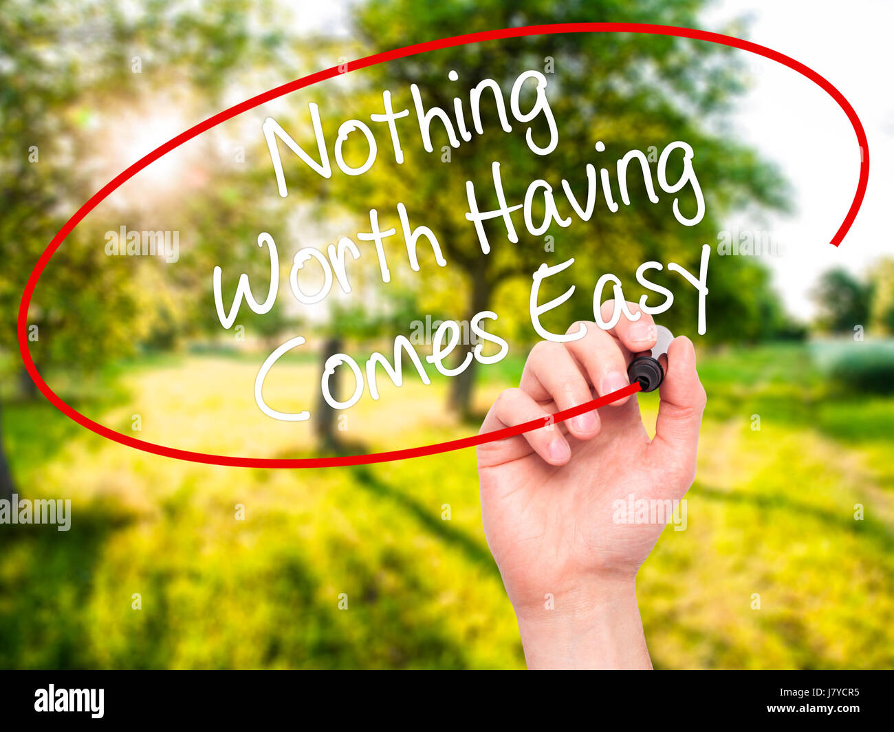 Man Hand writing Nothing Worth Having Comes Easy with black marker on ...