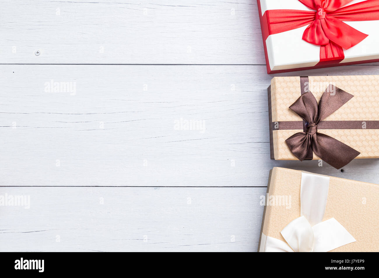 Top view color gift box with ribbon on white wooden plank background ...