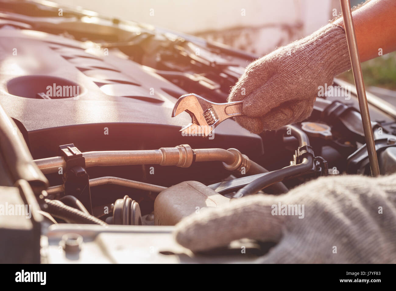 Hand of technician checking or fixing engine of modern car Stock Photo ...
