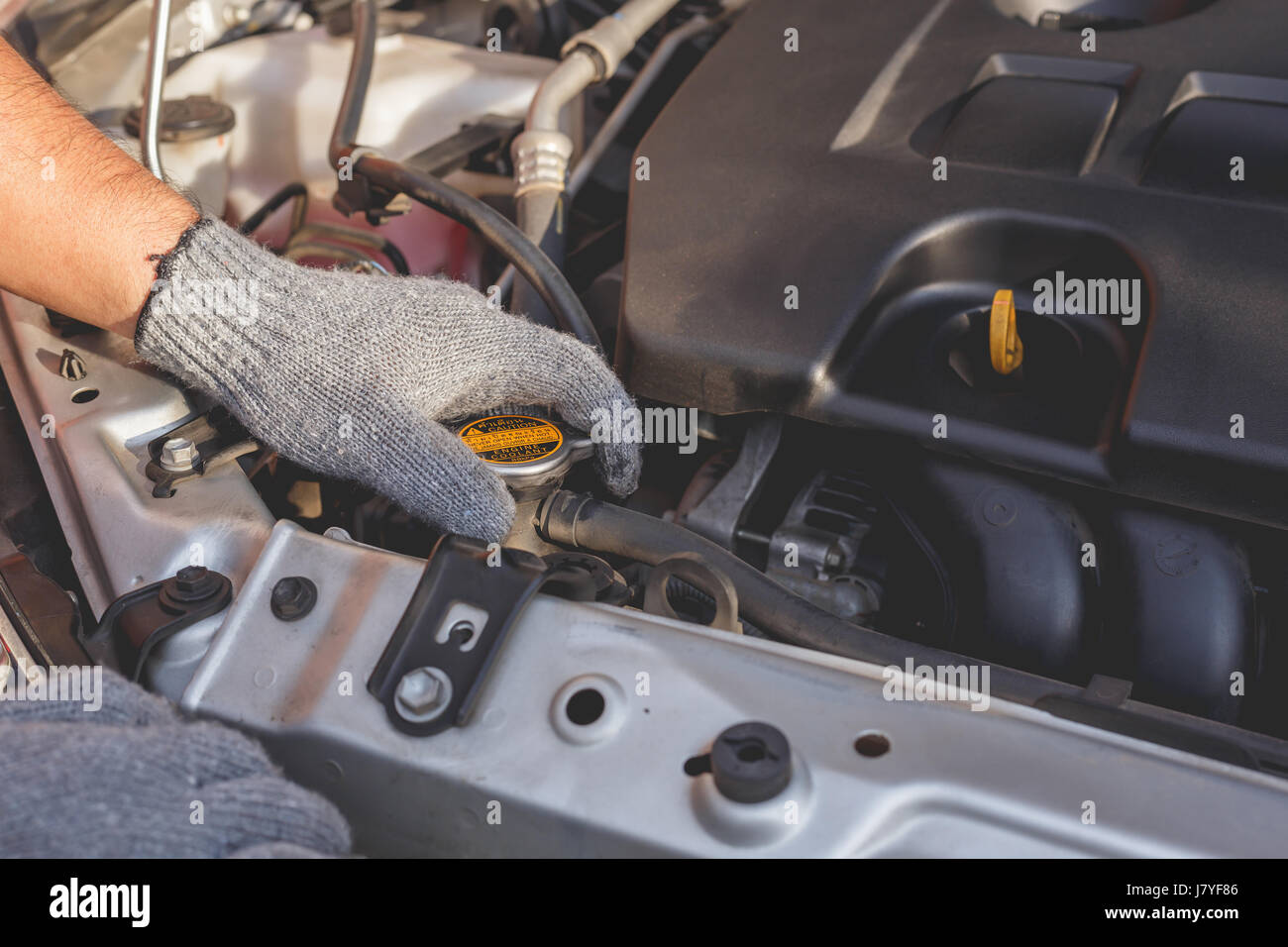 Hand of technician checking or fixing engine of modern car Stock Photo ...