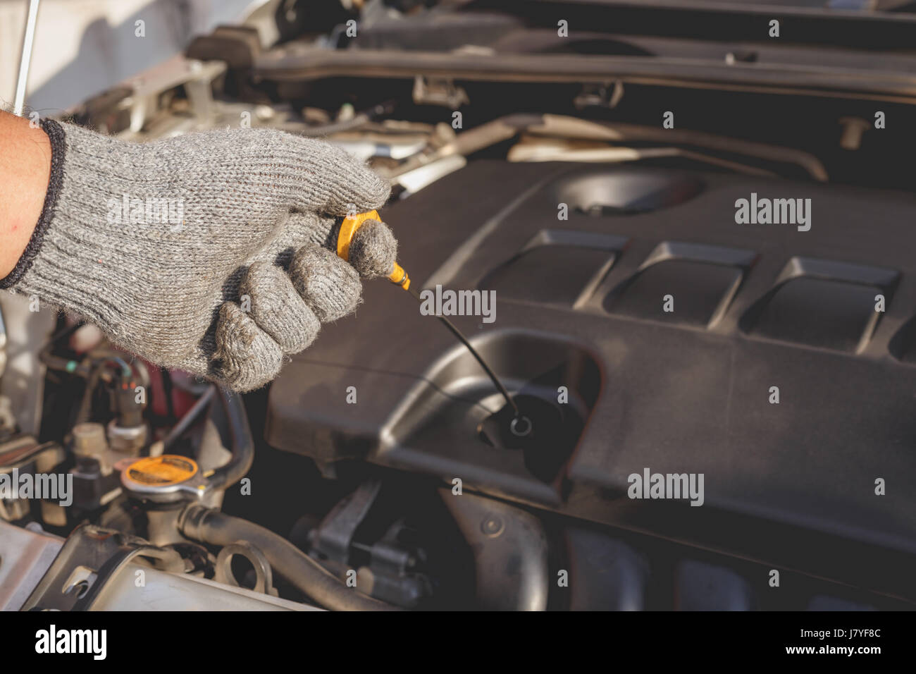 Hand of technician checking or fixing engine of modern car Stock Photo ...