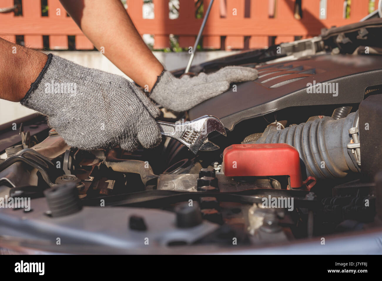 Hand of technician checking or fixing engine of modern car Stock Photo ...