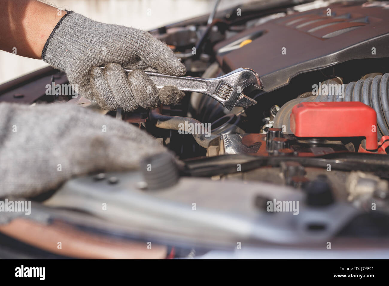 Hand of technician checking or fixing engine of modern car Stock Photo ...