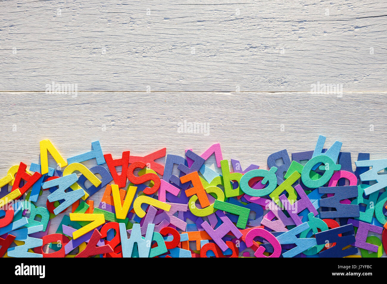 Colorful wooden alphabet. Top view on white wooden background Stock ...