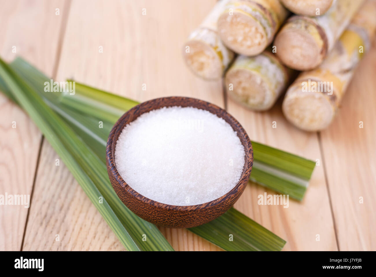 Close up white sugar and sugar cane on wooden table background Stock ...