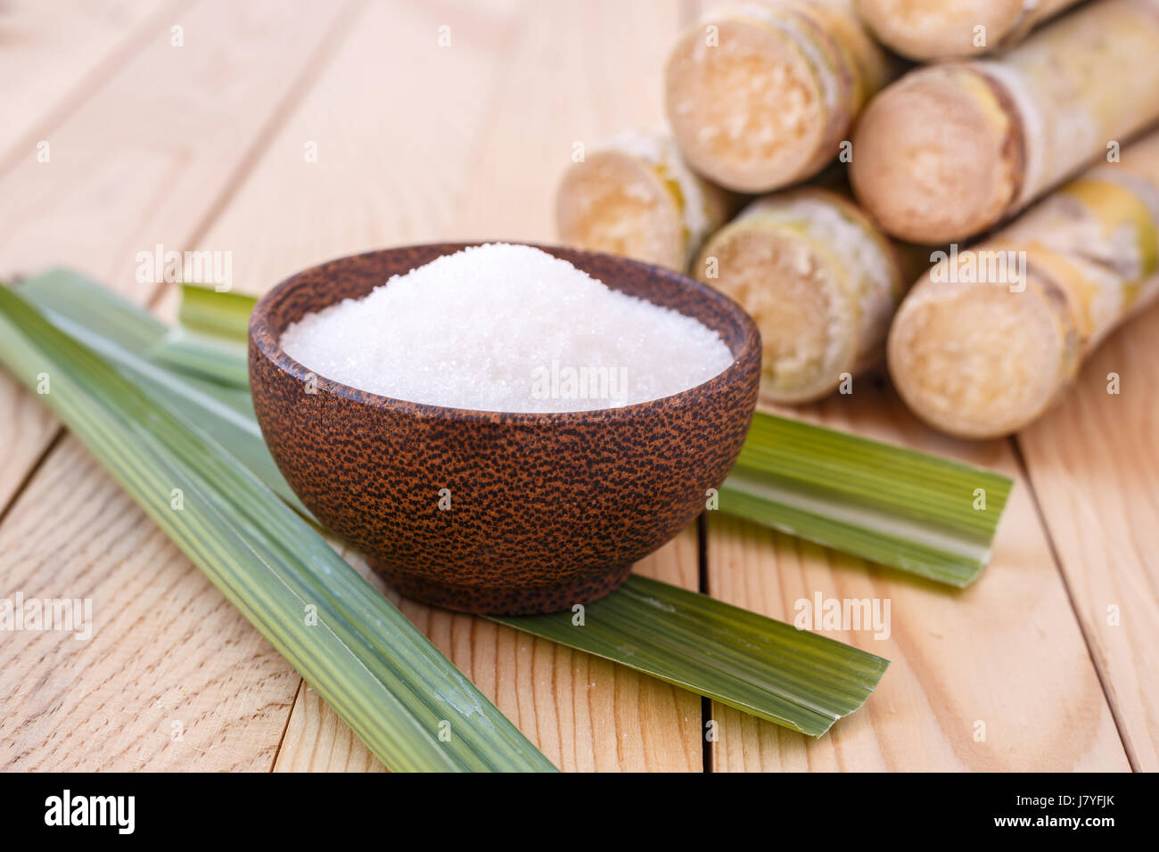 Close up white sugar and sugar cane on wooden table background Stock ...