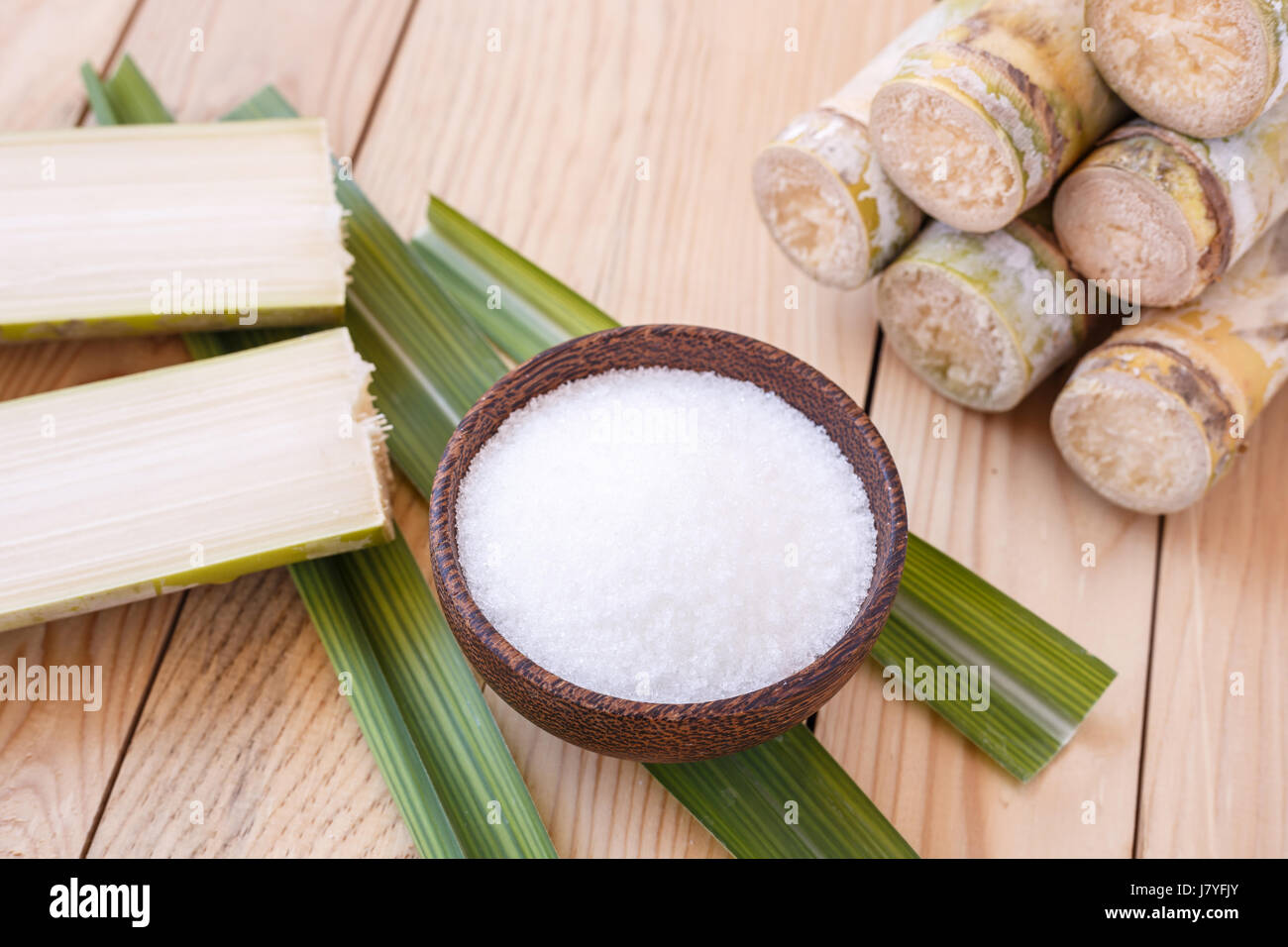Close up white sugar and sugar cane on wooden table background Stock ...