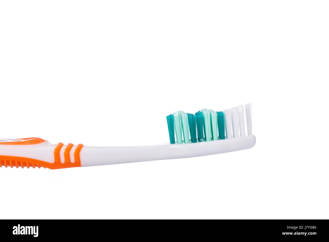 New orange toothbrush. Studio shot isolated on white background Stock ...