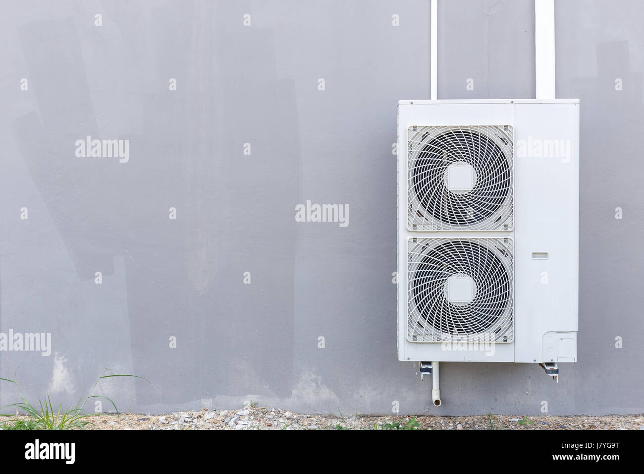 Outdoor air conditioning compressor installed the wall Stock Photo - Alamy