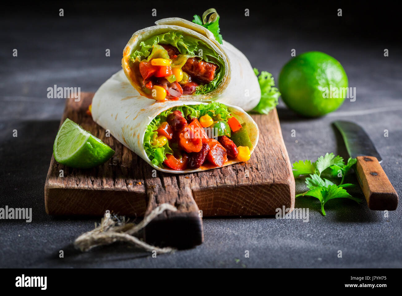 Spicy burrito with tomato sauce, vegetables and meat Stock Photo - Alamy
