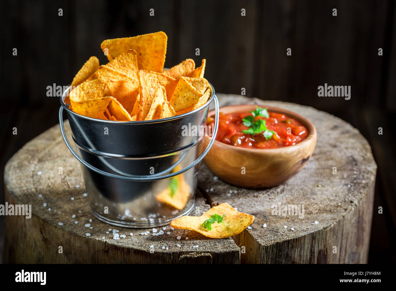 Crispy nachos with red pepper dip and salt Stock Photo - Alamy