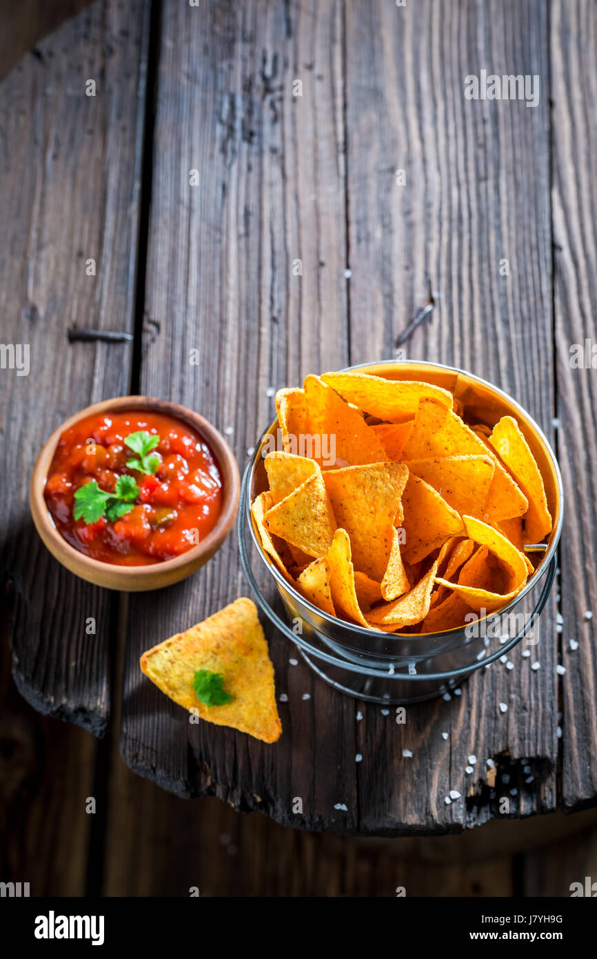 Golden nachos with red pepper dip and salt Stock Photo - Alamy