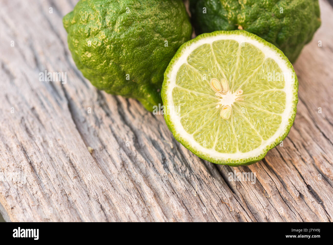 Close up slice green fresh Bergamot fruit on wooden table background ...