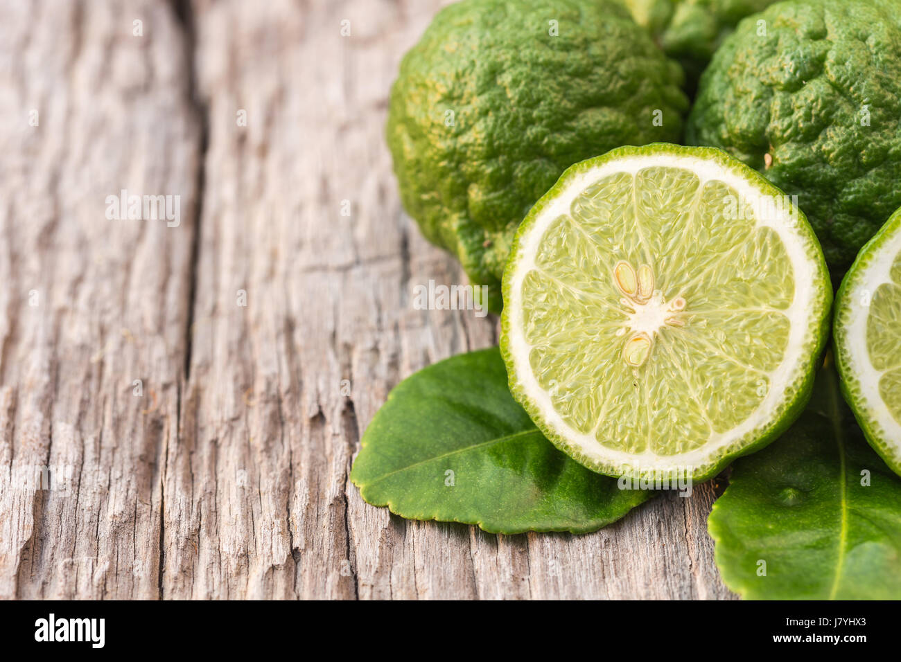 Close up slice green fresh Bergamot fruit on wooden table background ...