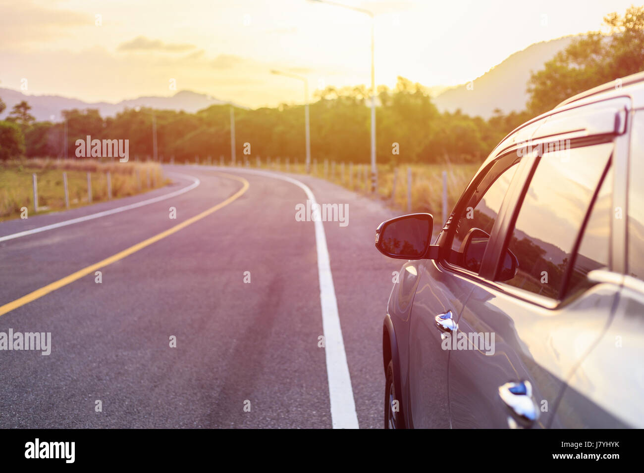 View from back side of new silver SUV car parking on the asphalt road ...