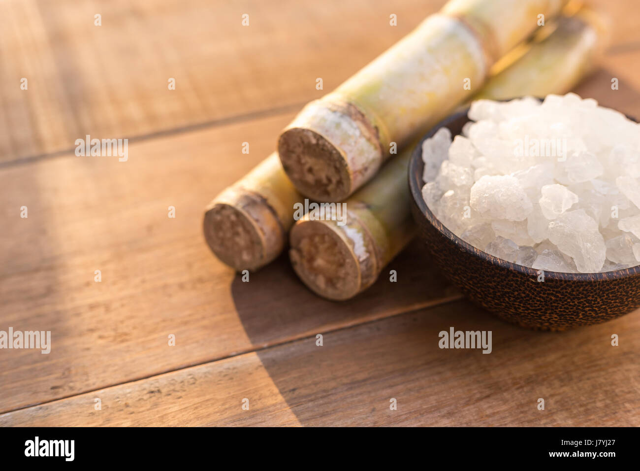 Close up rock sugar and sugar cane on wooden table background with ...
