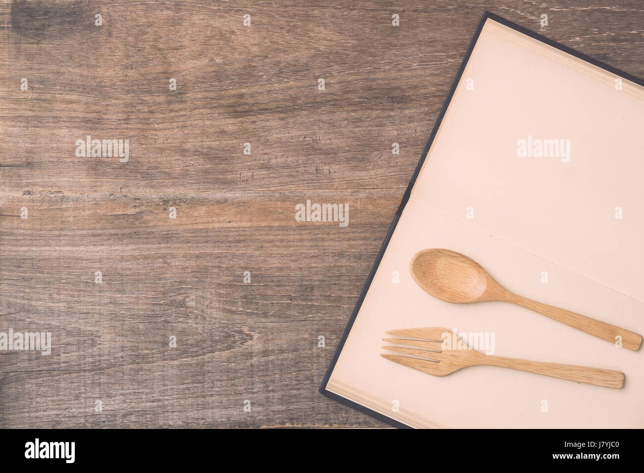 Top view spoon, fork and book on wooden plank background. Eating ...