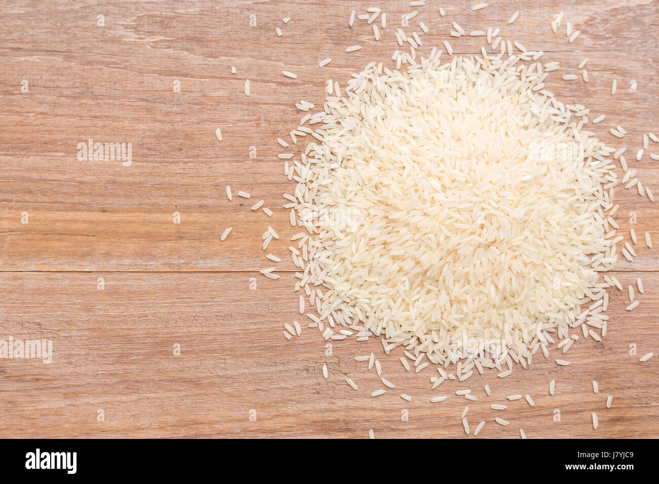 Top view Thai jasmine rice put on wooden plank background Stock Photo ...