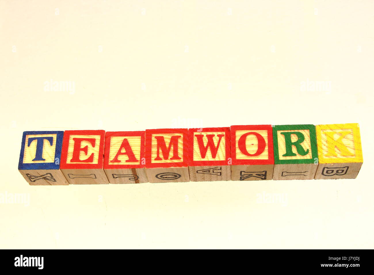 The term teamwork displayed visually using colorful wooden toy blocks ...