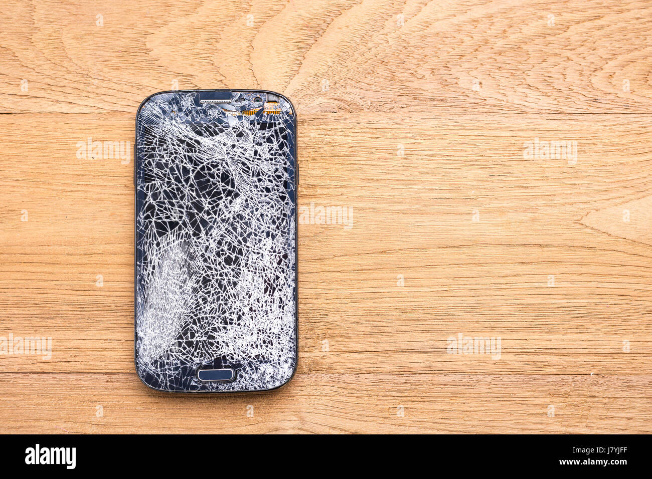 Top view broken of black smart phone on wooden table background Stock ...