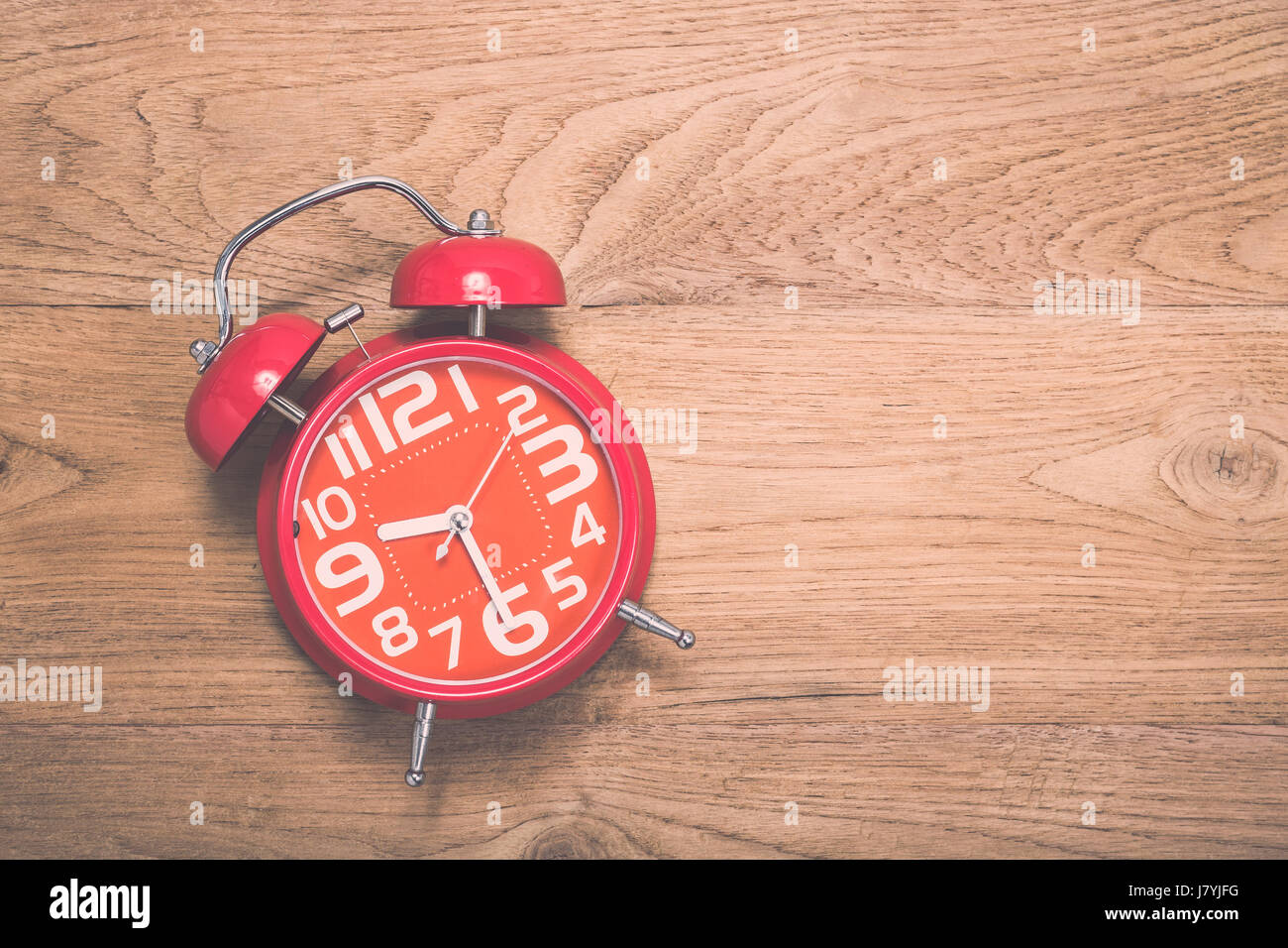 Top view of red alarm clock on old brown wooden plank background Stock ...