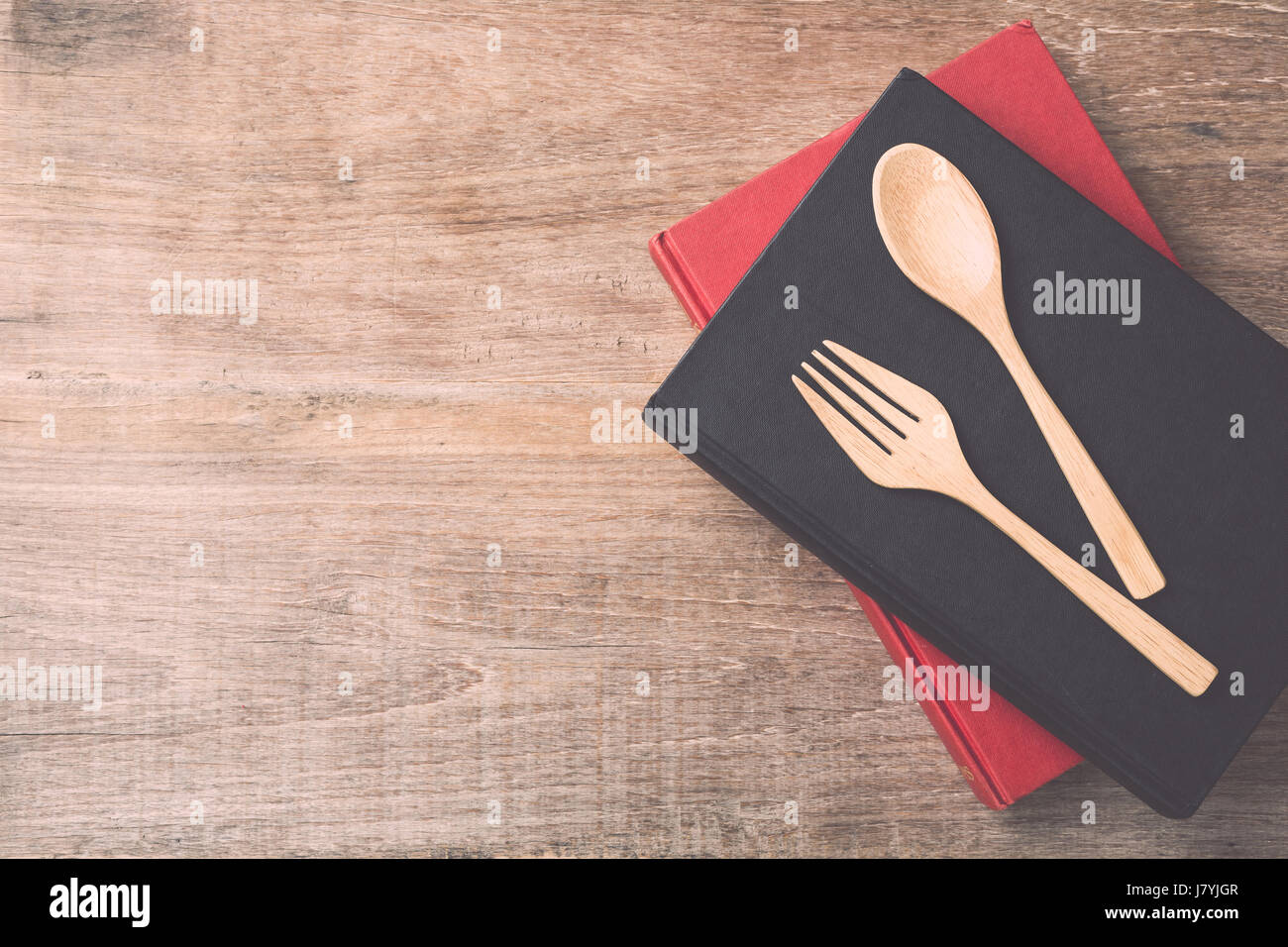 Top view spoon, fork and book on wooden plank background. Eating ...