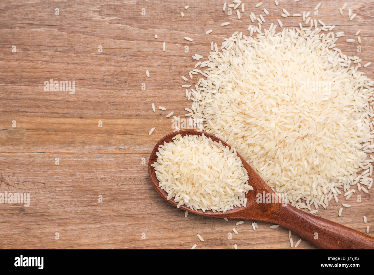 Top view Thai jasmine rice put on wooden plank background Stock Photo ...