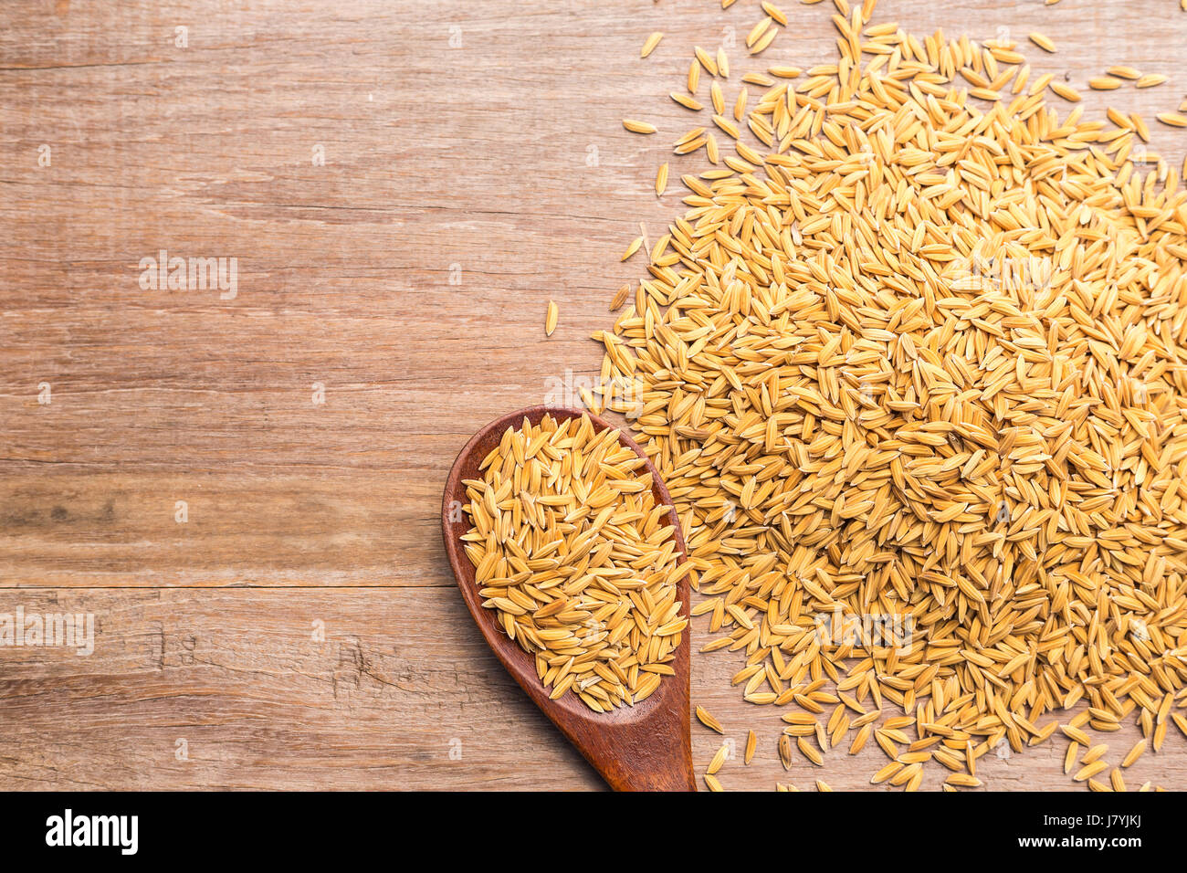 Top view Thai yellow paddy rice put on wooden plank background Stock ...