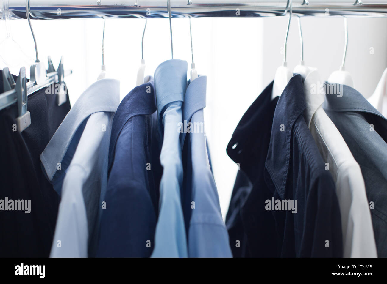 Set of male elegant shirts hanging on a rack, businessman outfit and ...