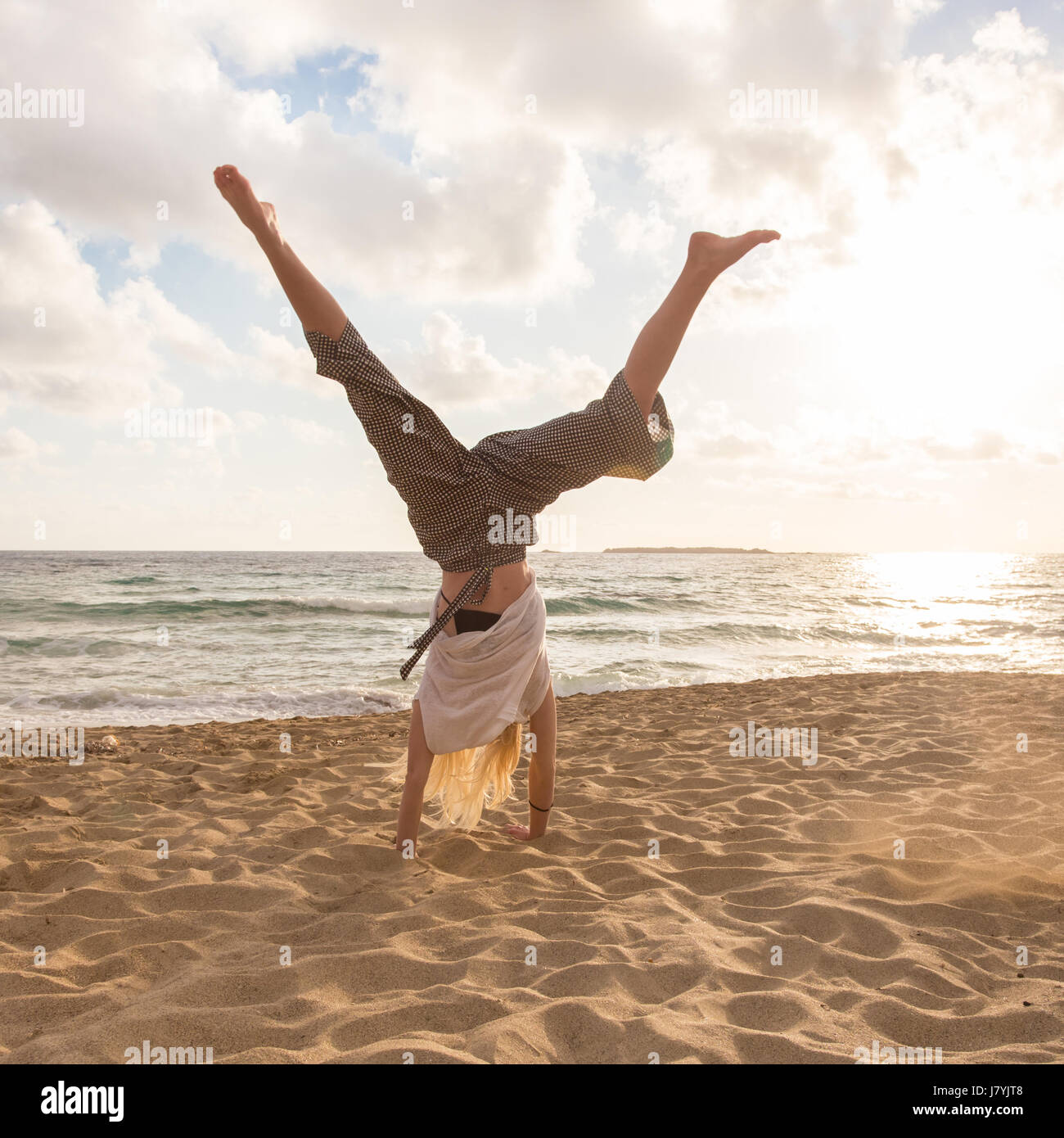 Woman turning cartwheel hi-res stock photography and images - Alamy