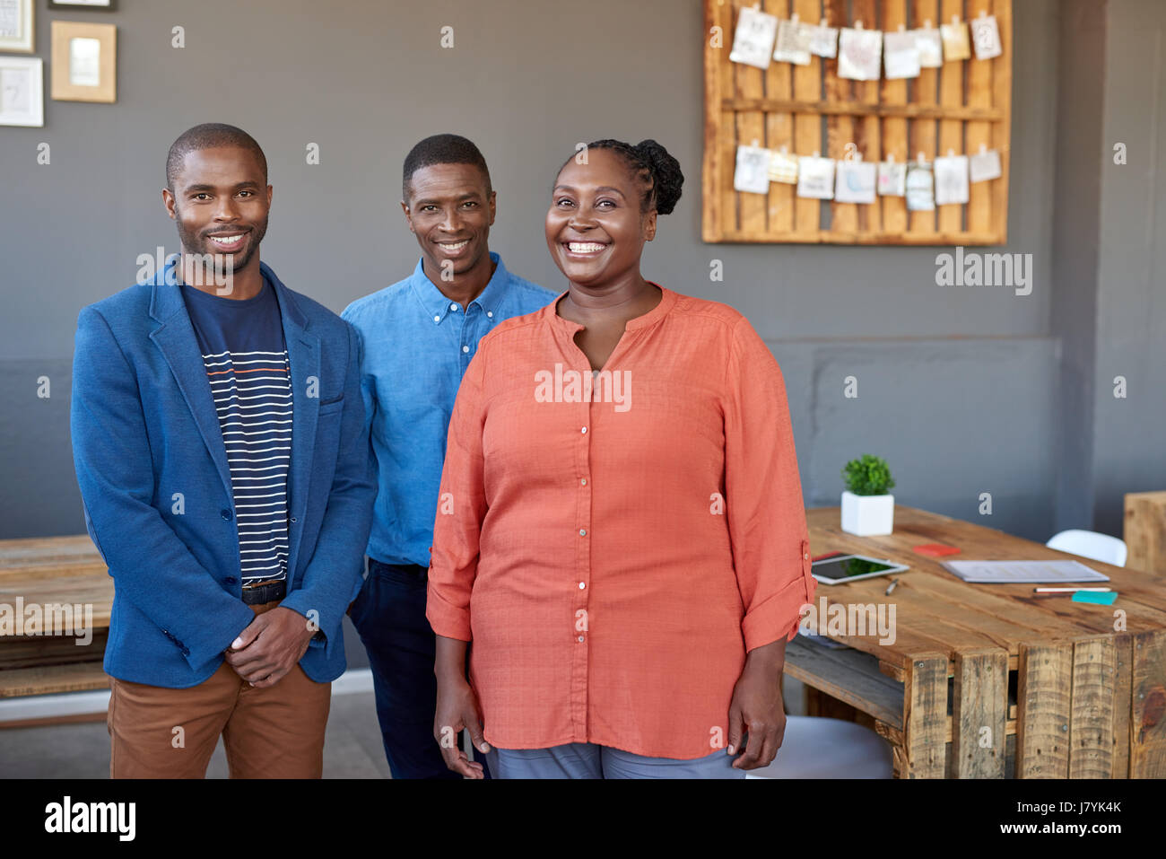 Smiling young African coworkers standing together in an office Stock ...
