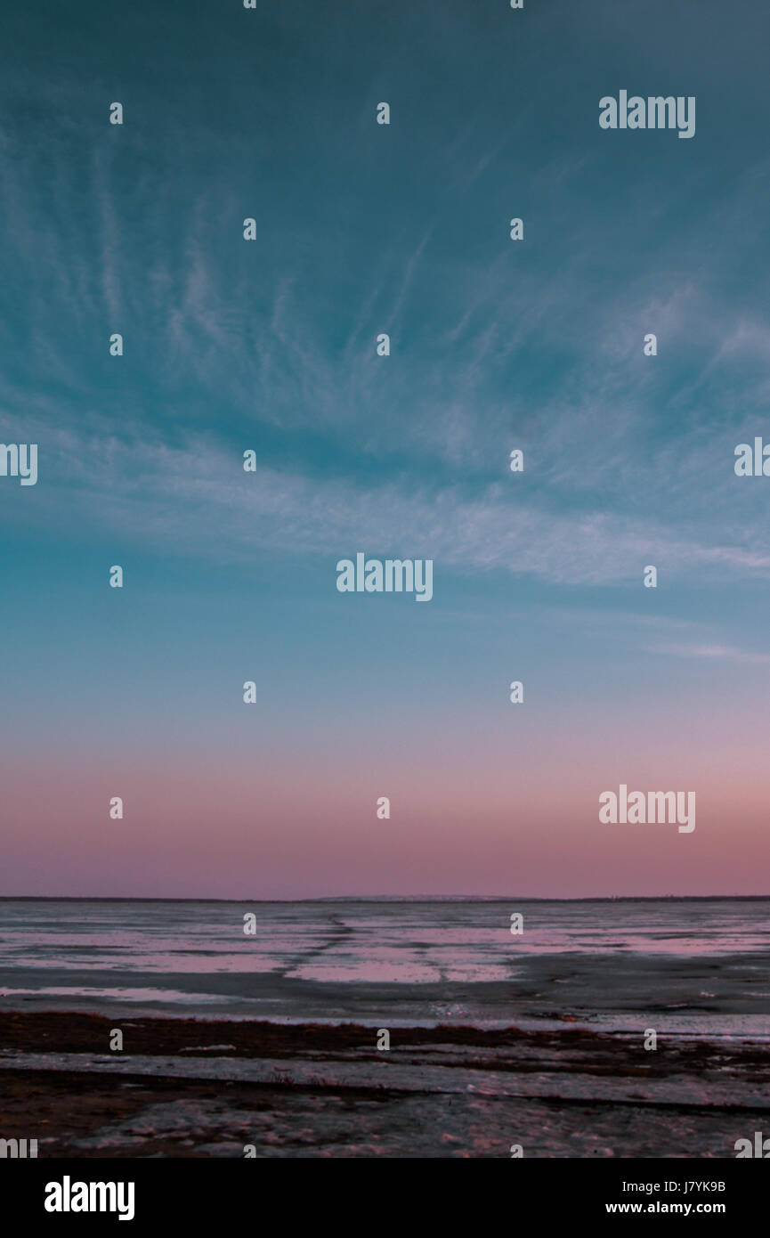 A colorful sunset sky over an icy lake. Landscape Stock Photo - Alamy