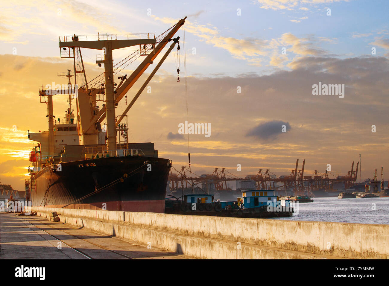 container ship loading material goods from local ship in habor port use ...