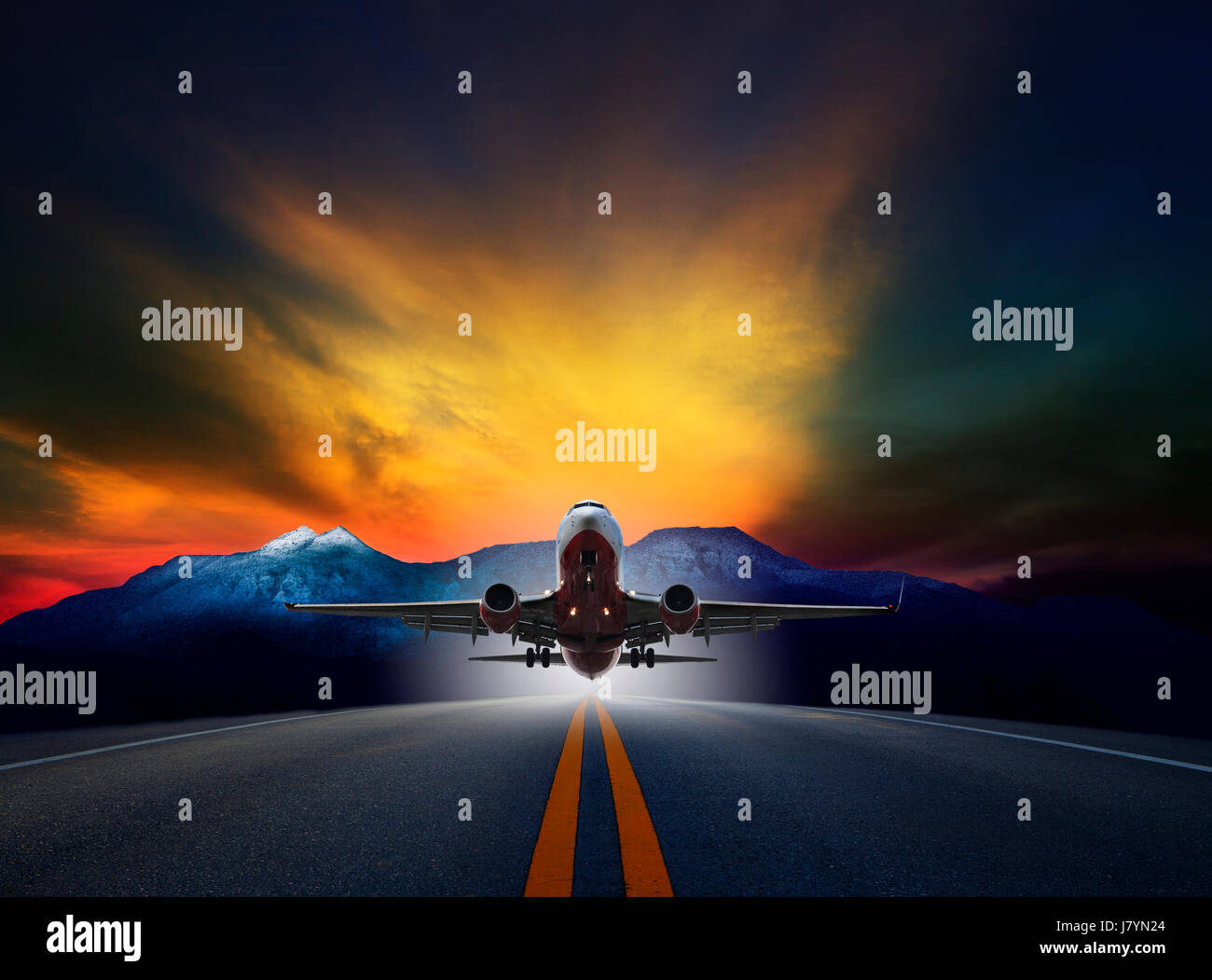 jet plane flying over runways against rock mountain and beautiful dusky ...