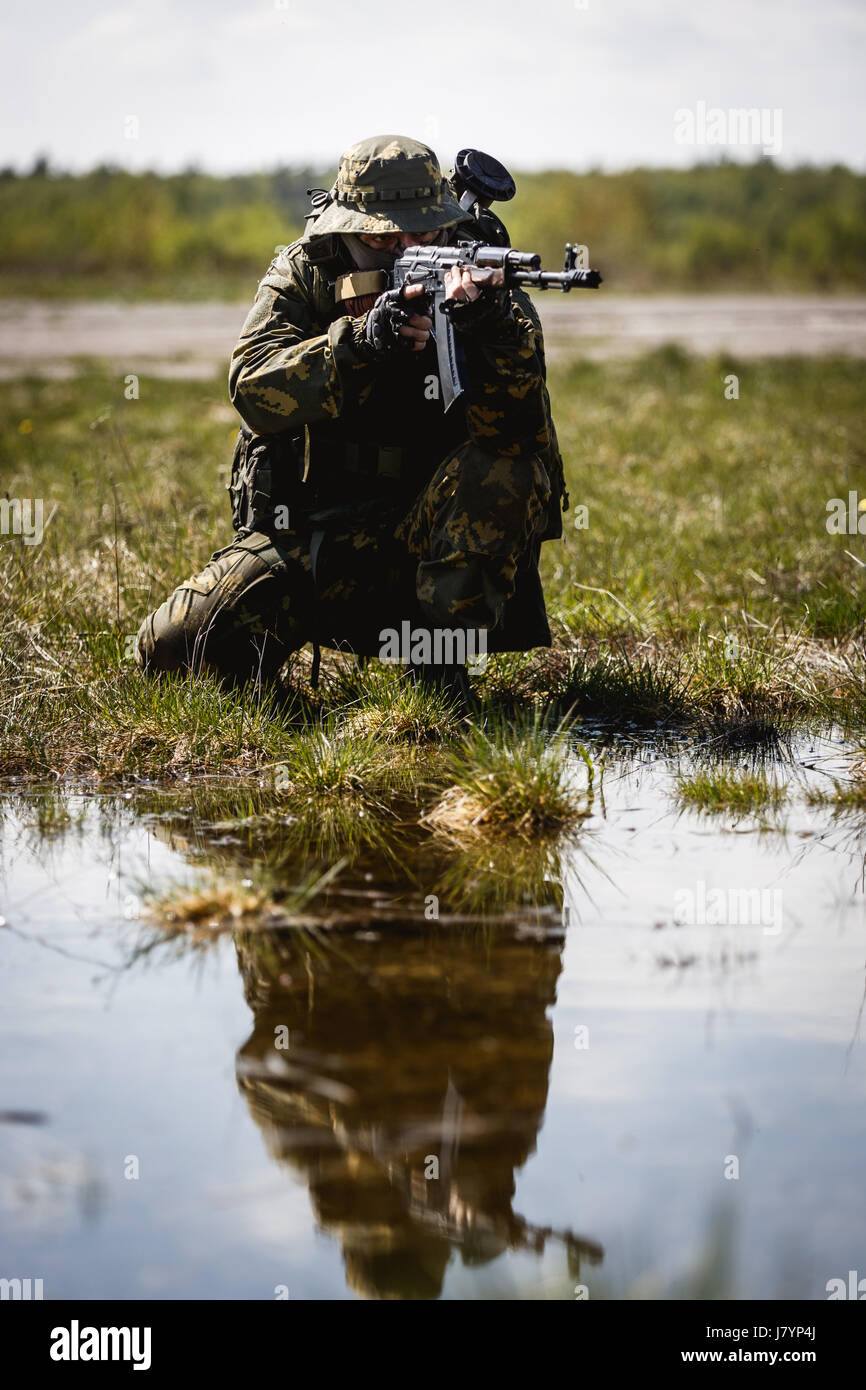 Photo of military man with gun in field during day Stock Photo - Alamy