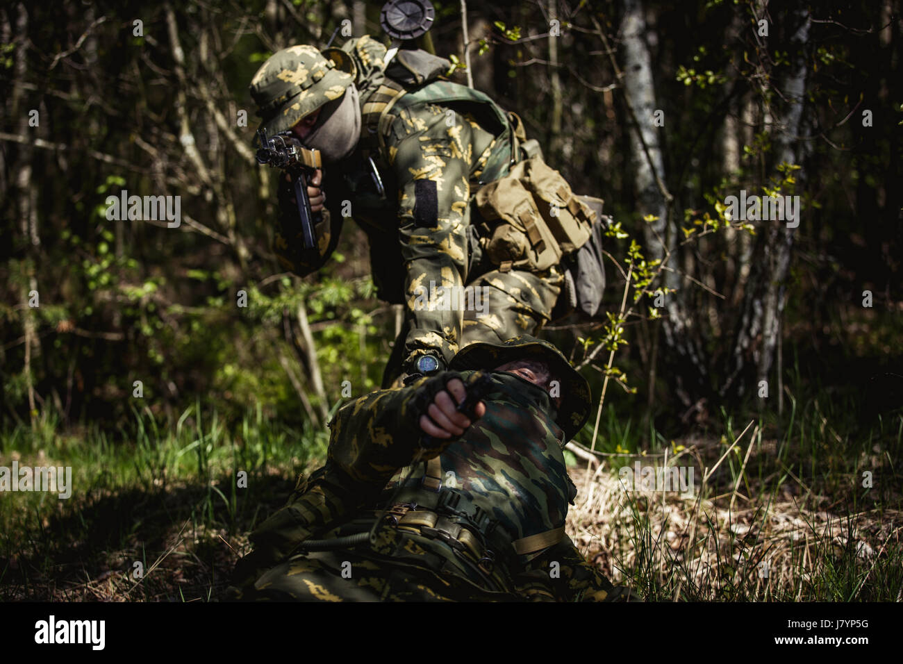 The soldier saves his comrade in battle Stock Photo - Alamy