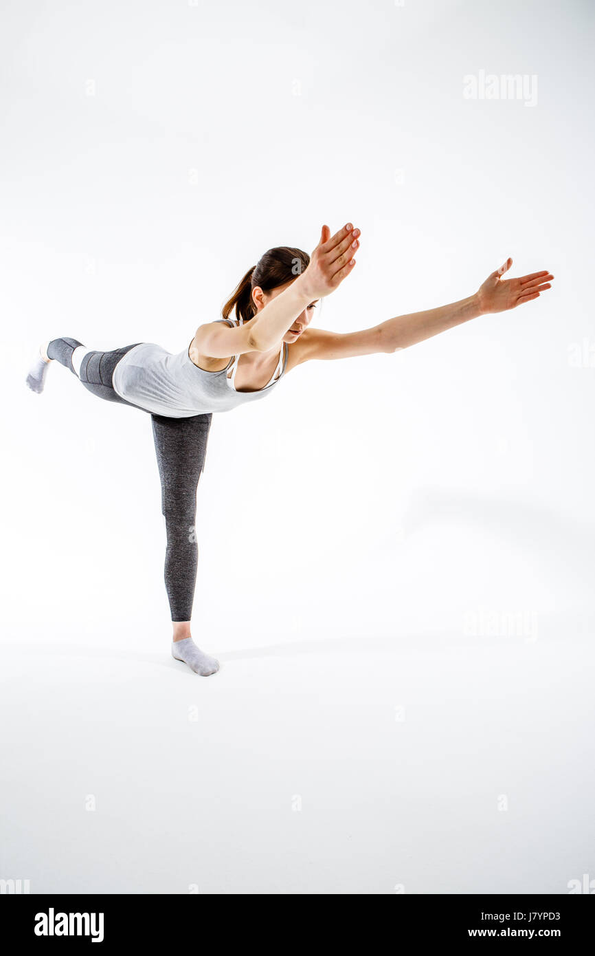 Woman balancing on one leg at isolated background Stock Photo - Alamy