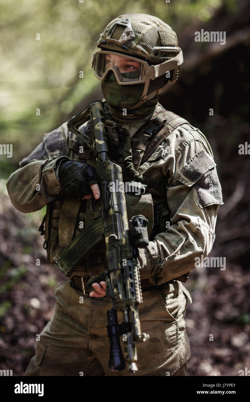 Photo of soldier with gun in woods during day Stock Photo - Alamy