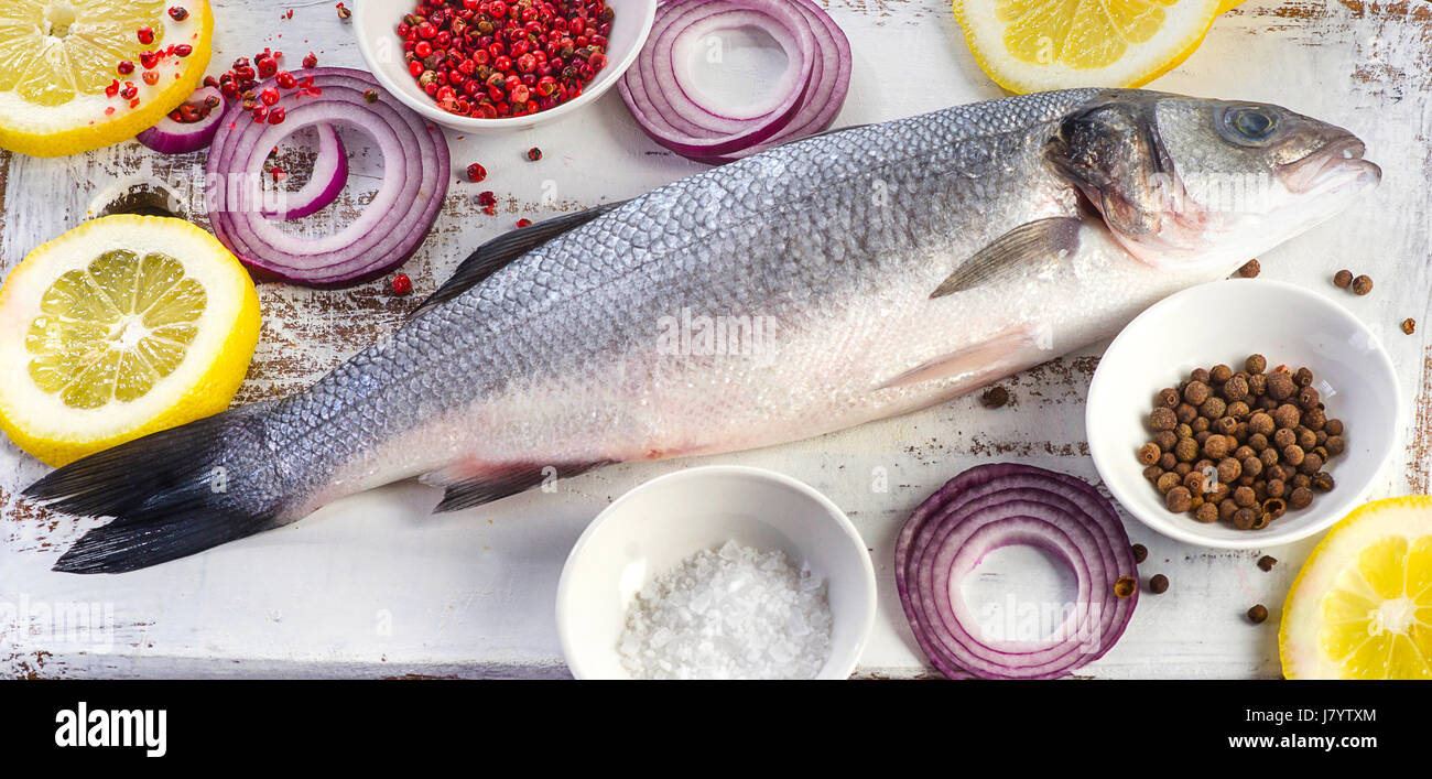 Raw Fish with spices, salt, lemon and onion slices. Healthy food, diet ...