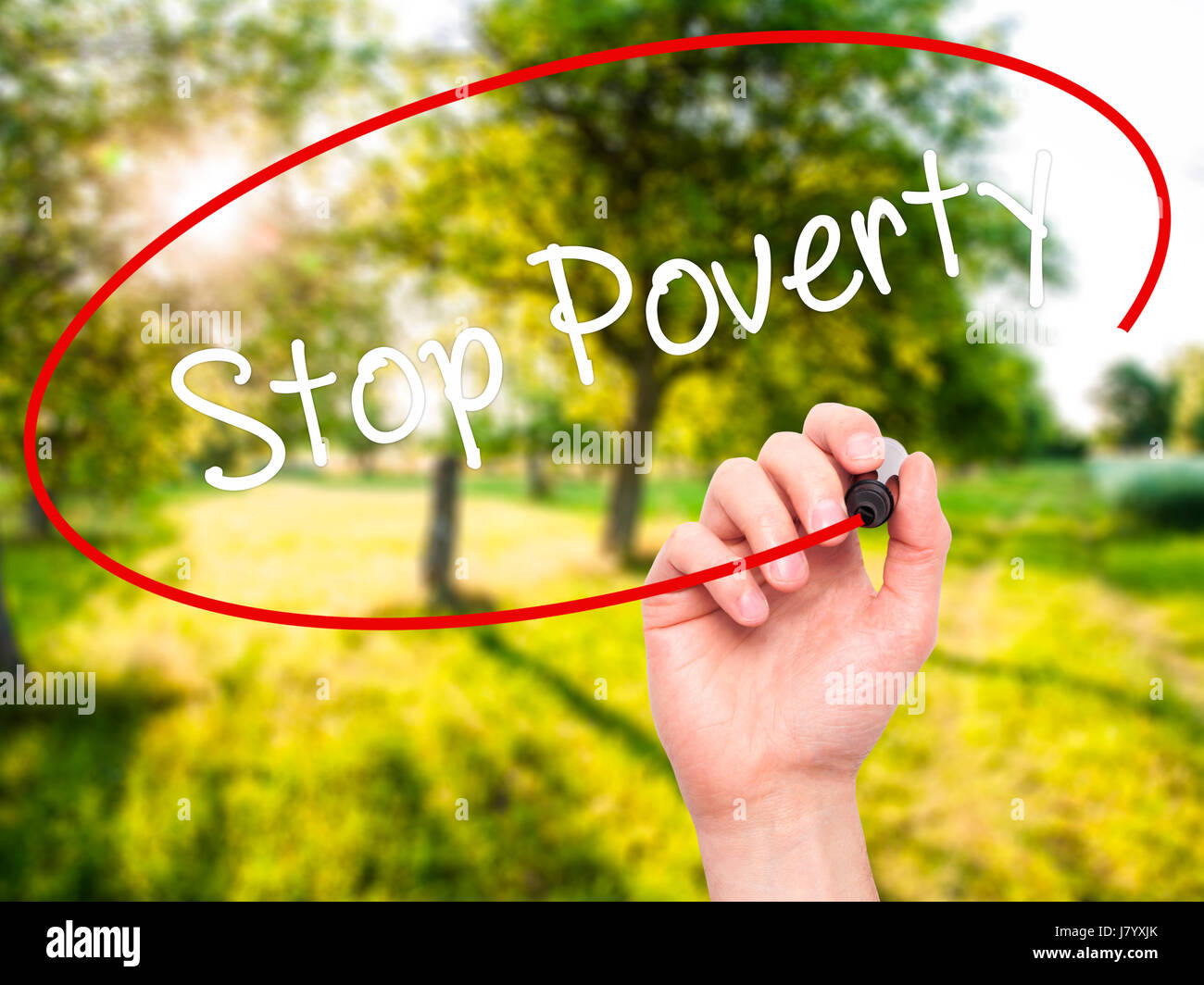 Man Hand writing Stop Poverty with black marker on visual screen ...