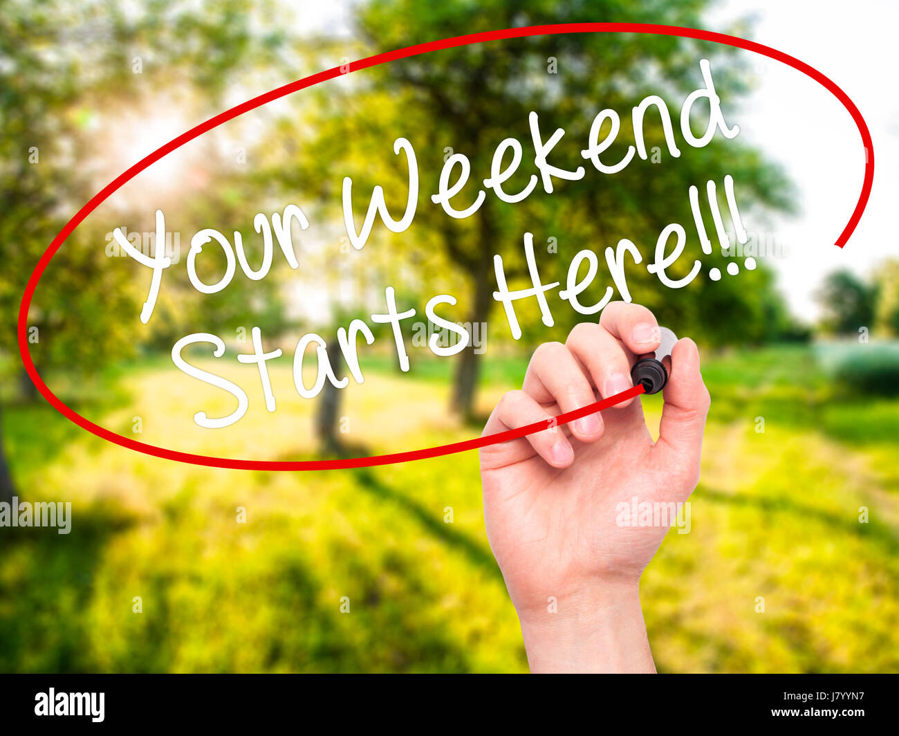Man Hand writing Your Weekend Starts Here!!! with black marker on ...