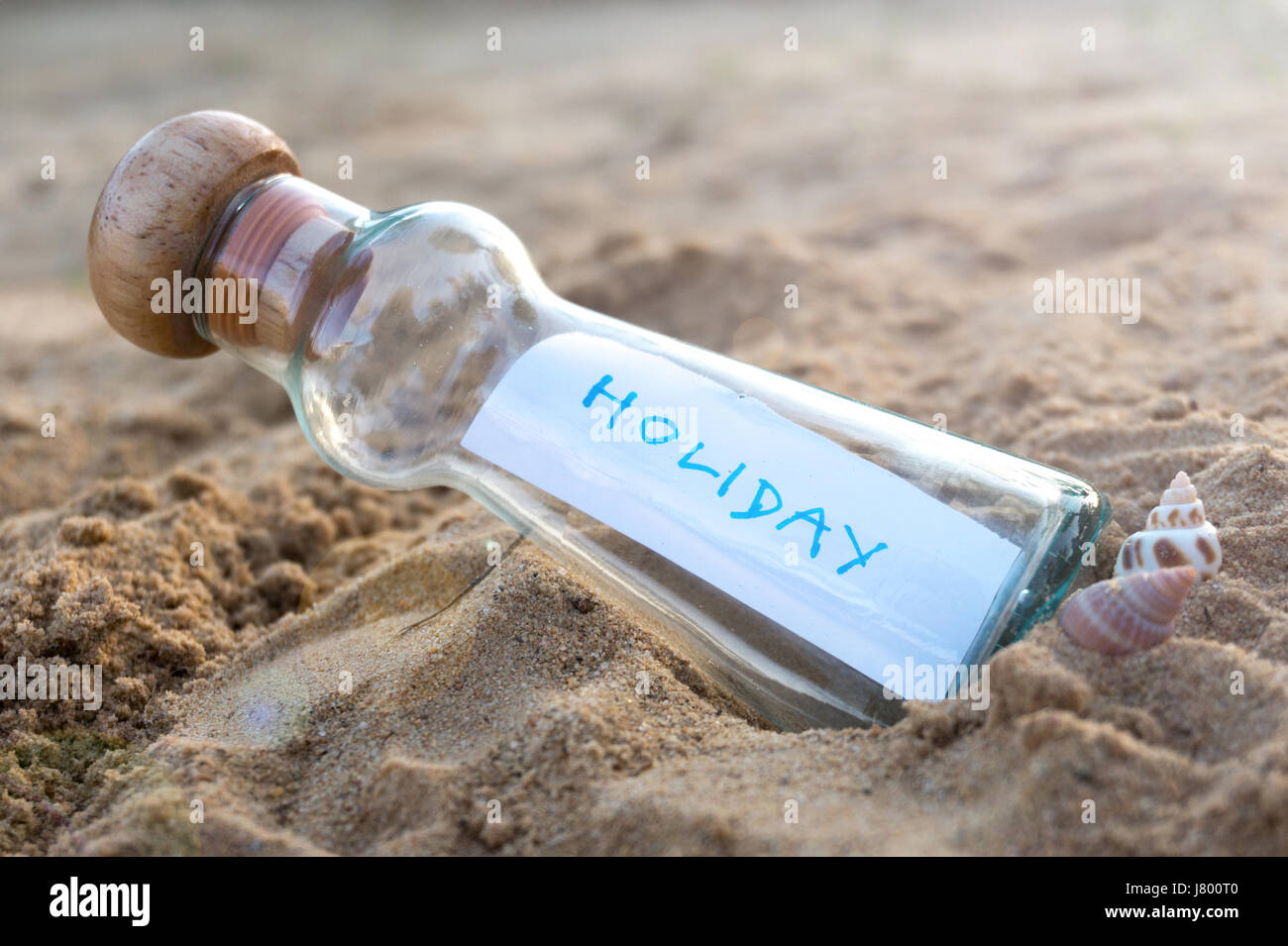 Message in glass bottle on sand background Stock Photo - Alamy