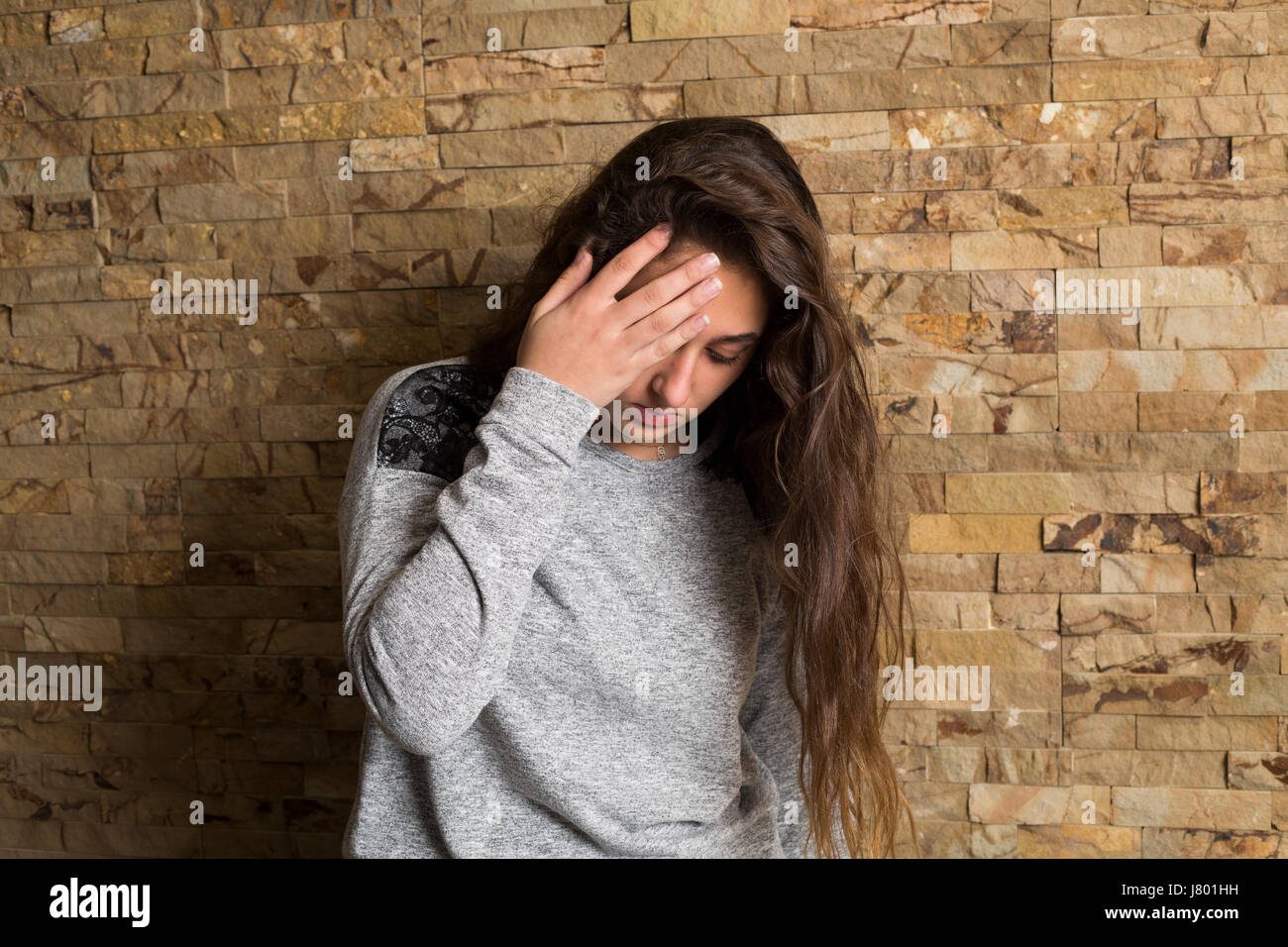 Sad teen girl head in hands Stock Photo - Alamy