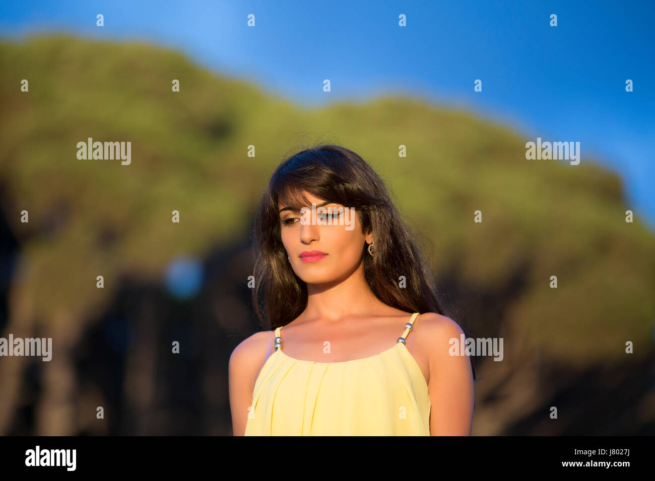 Pensive young woman looking away Stock Photo - Alamy