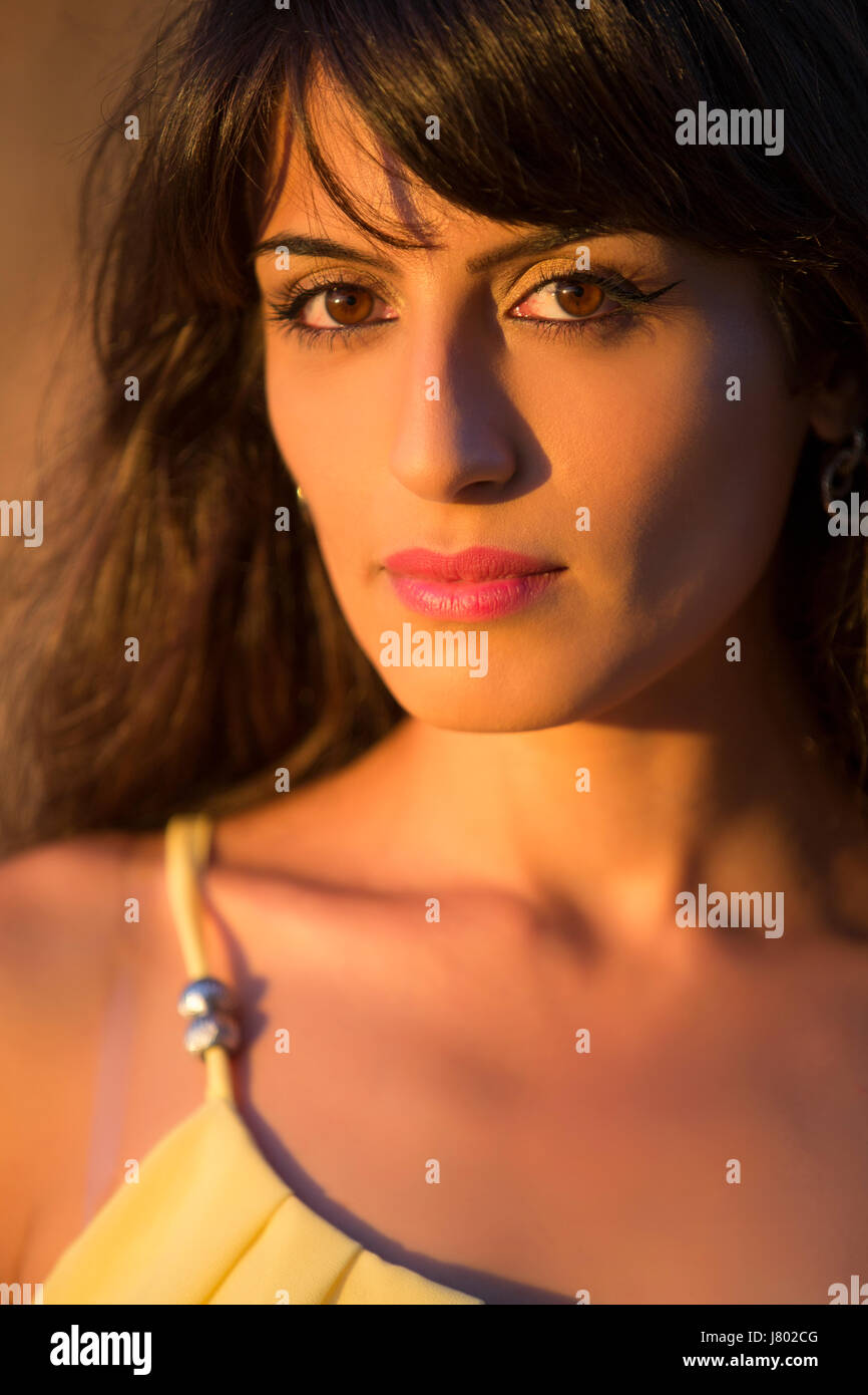 Beautiful young woman staring outdoors Stock Photo - Alamy
